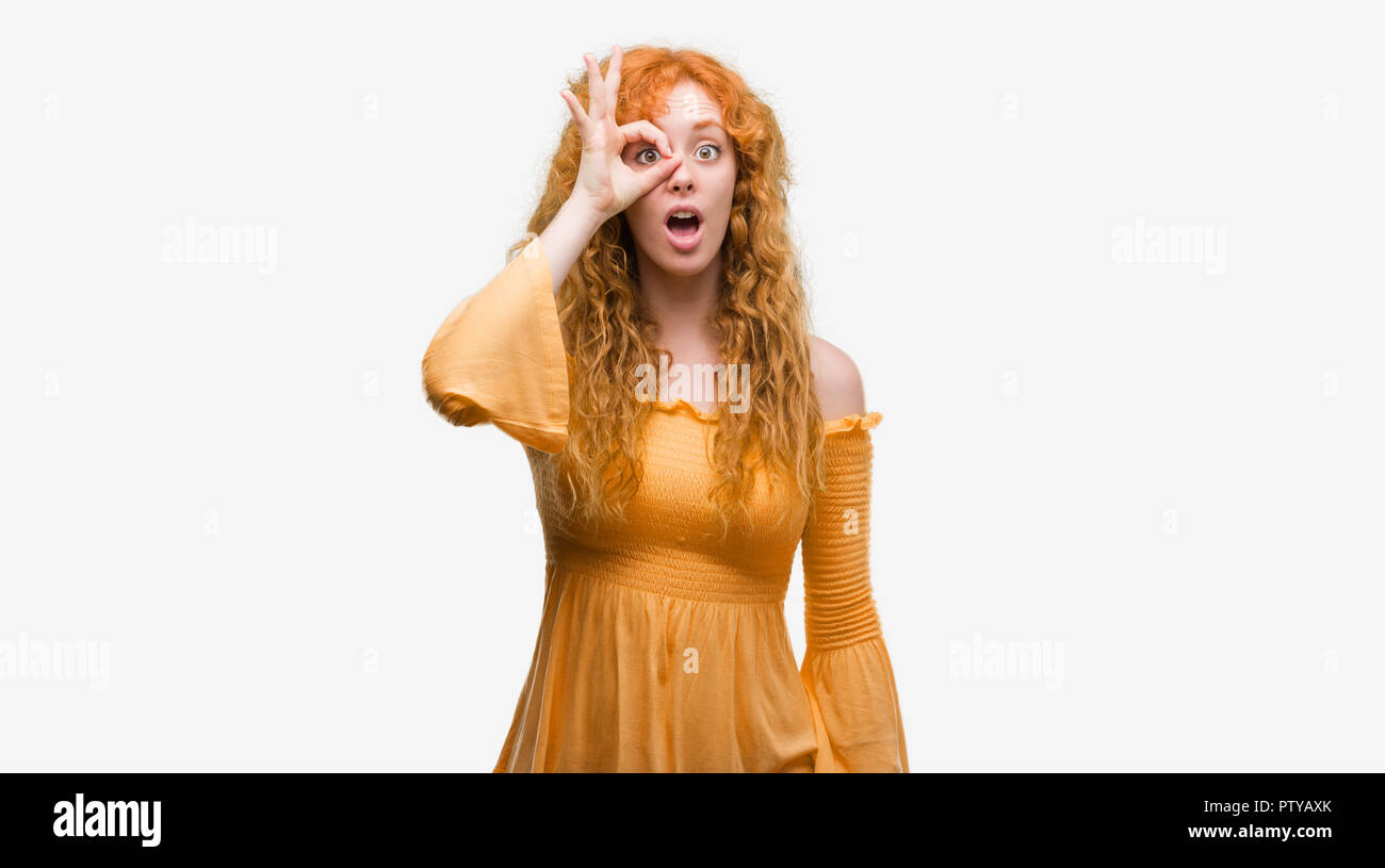 Young redhead woman doing ok gesture shocked with surprised face, eye ...