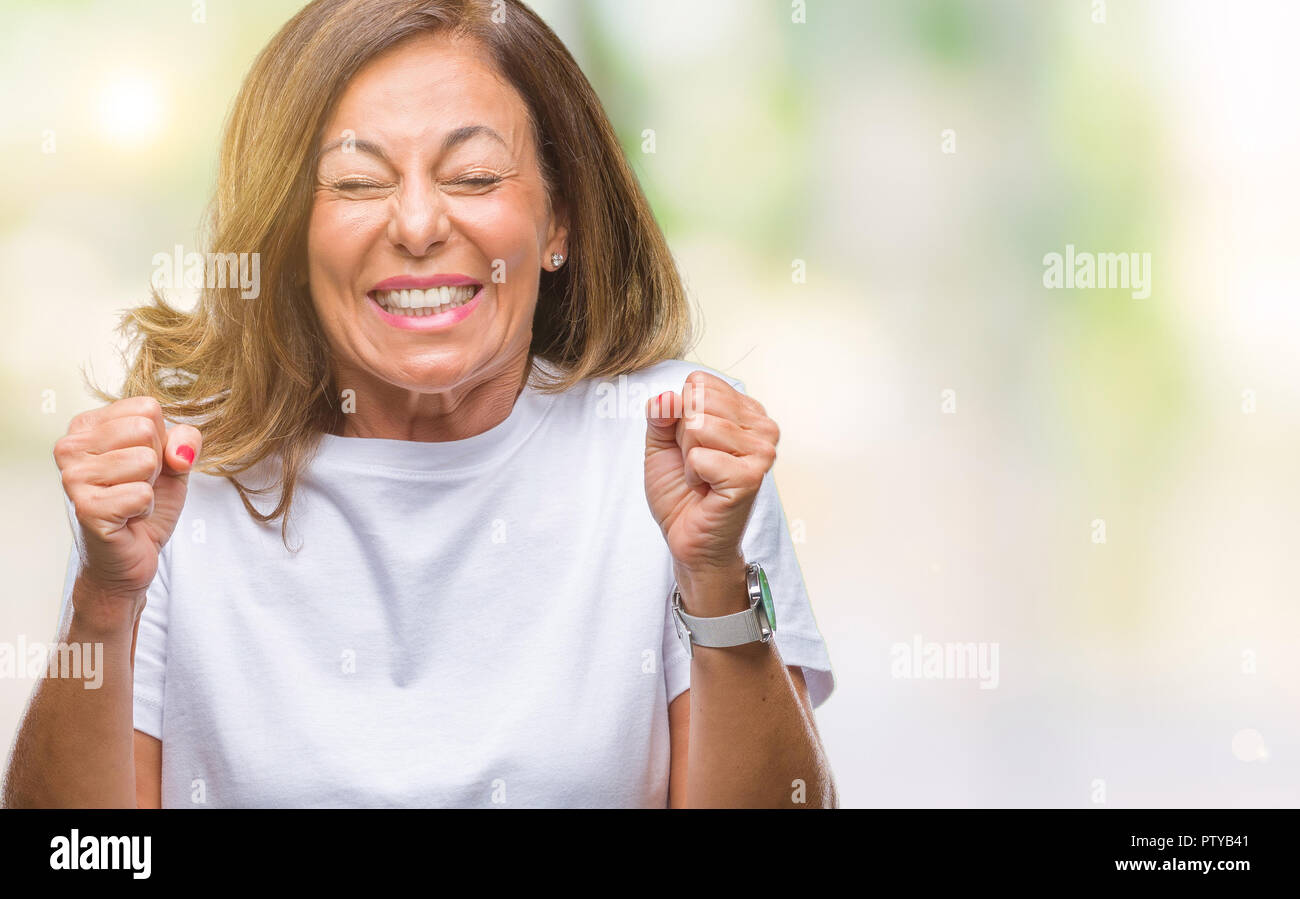 Middle age senior hispanic woman over isolated background excited for ...