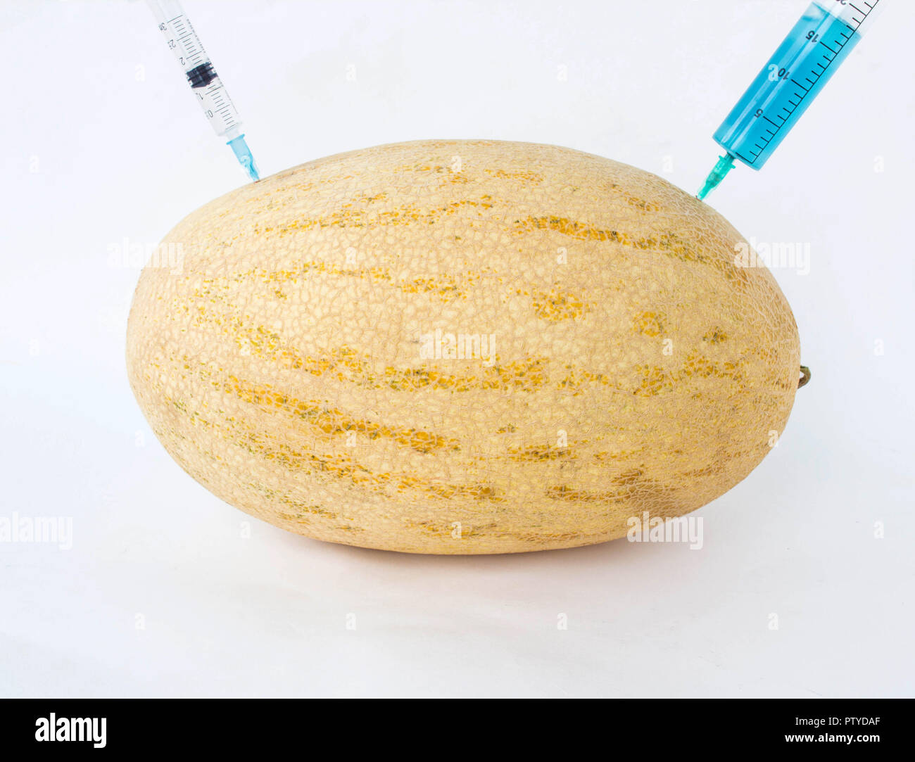 Melon on a white background in which enter gmo and nitrates, close-up ...
