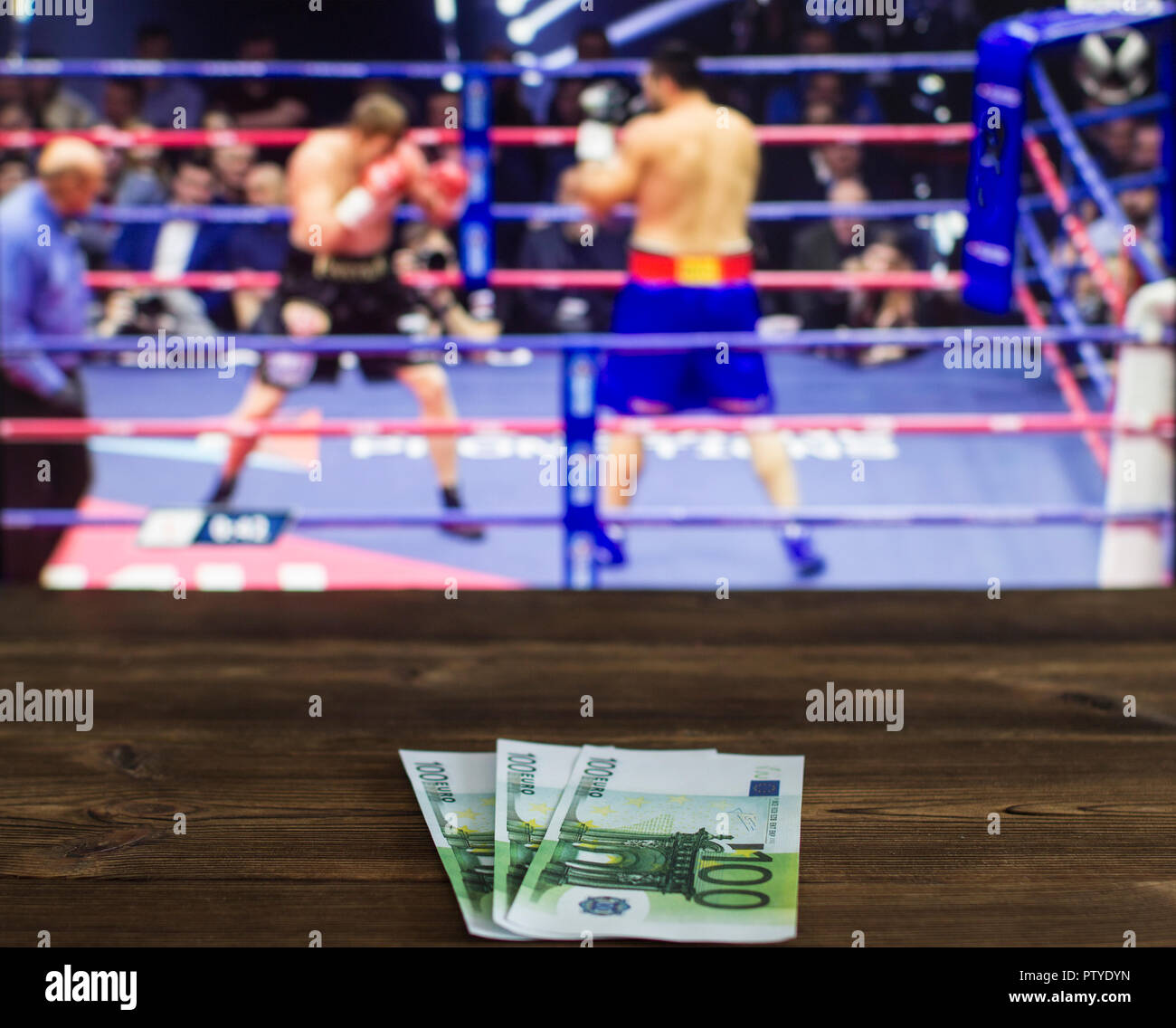 Euro money against the background of the TV on which show boxing, ring ...