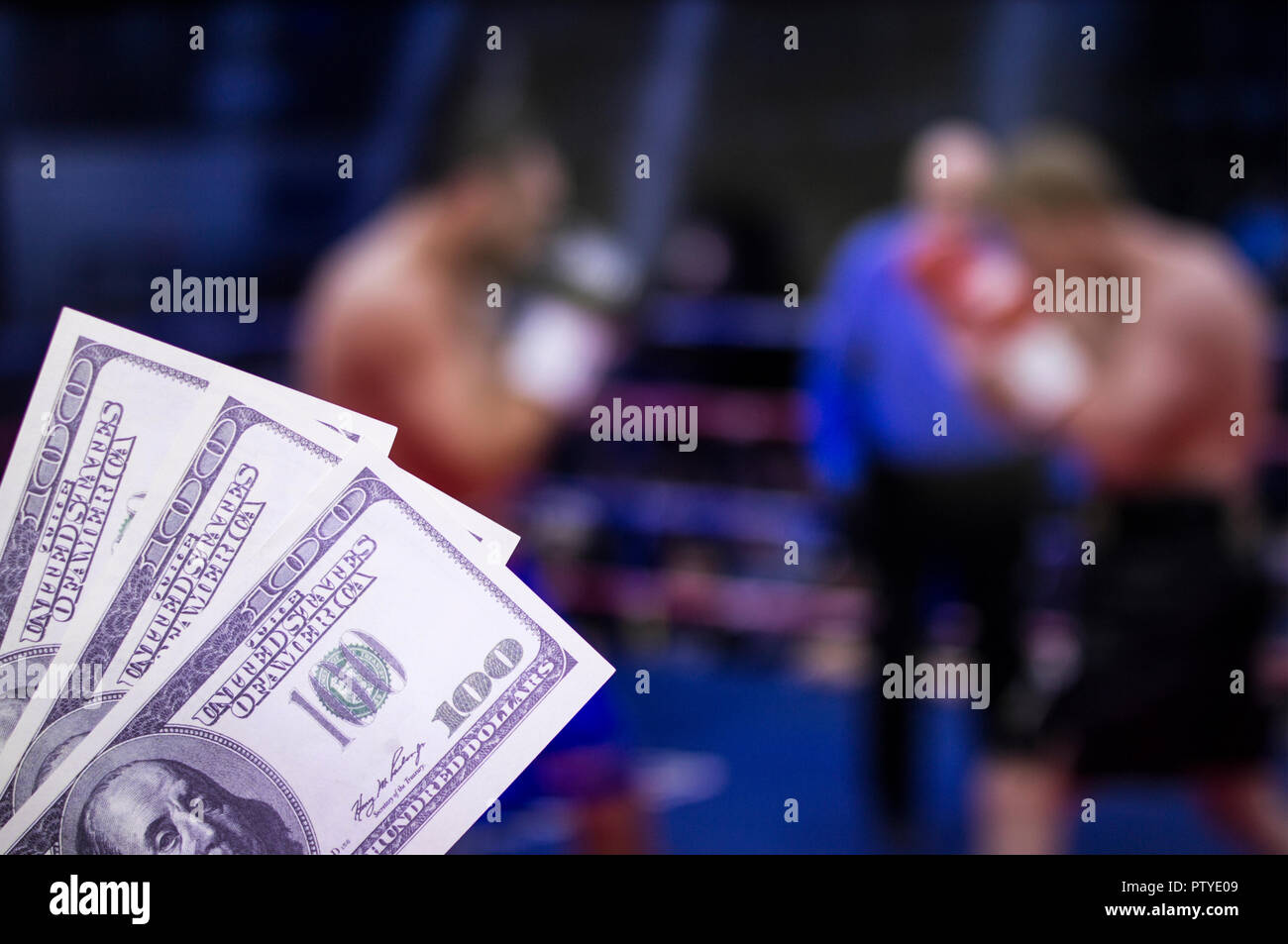 Money dollars against the background of the TV on which show boxing ...