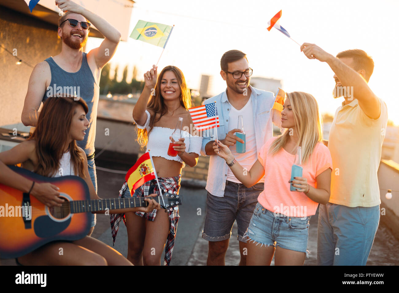 Friends having fun and drinking outdoor on a rooftop get together Stock ...