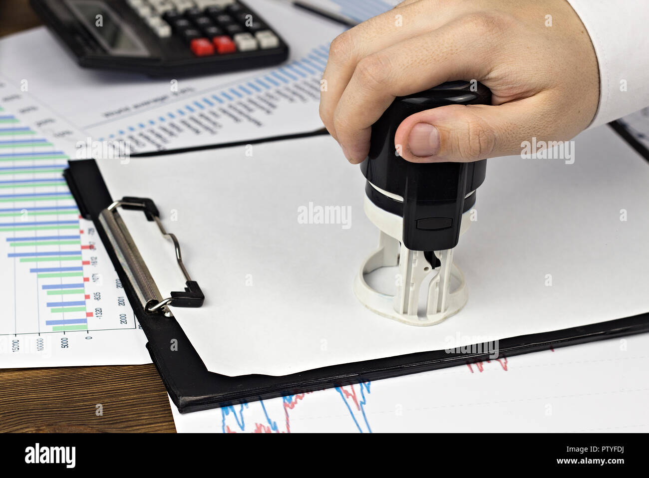 A man puts a seal on a blank sheet Stock Photo - Alamy