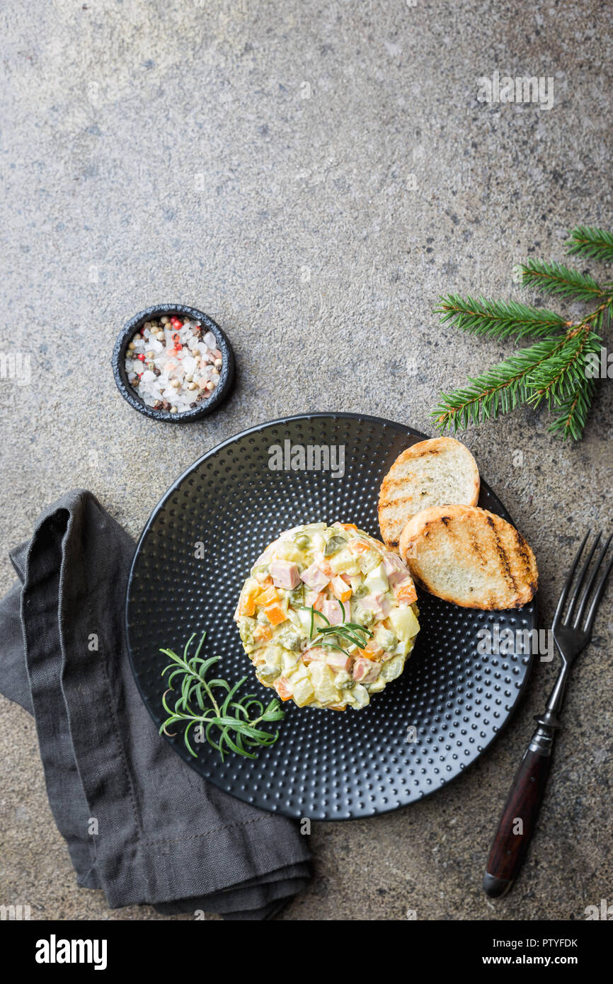 Traditional Russian salad with cooked vegetables and mayonnaise in a ...