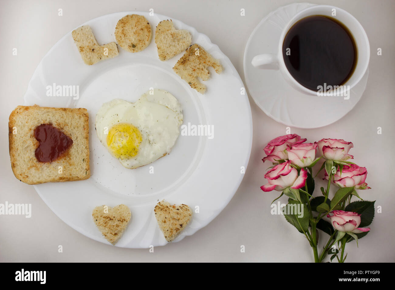 Breakfast for lovers, scrambled eggs,coffee, roses Stock Photo - Alamy