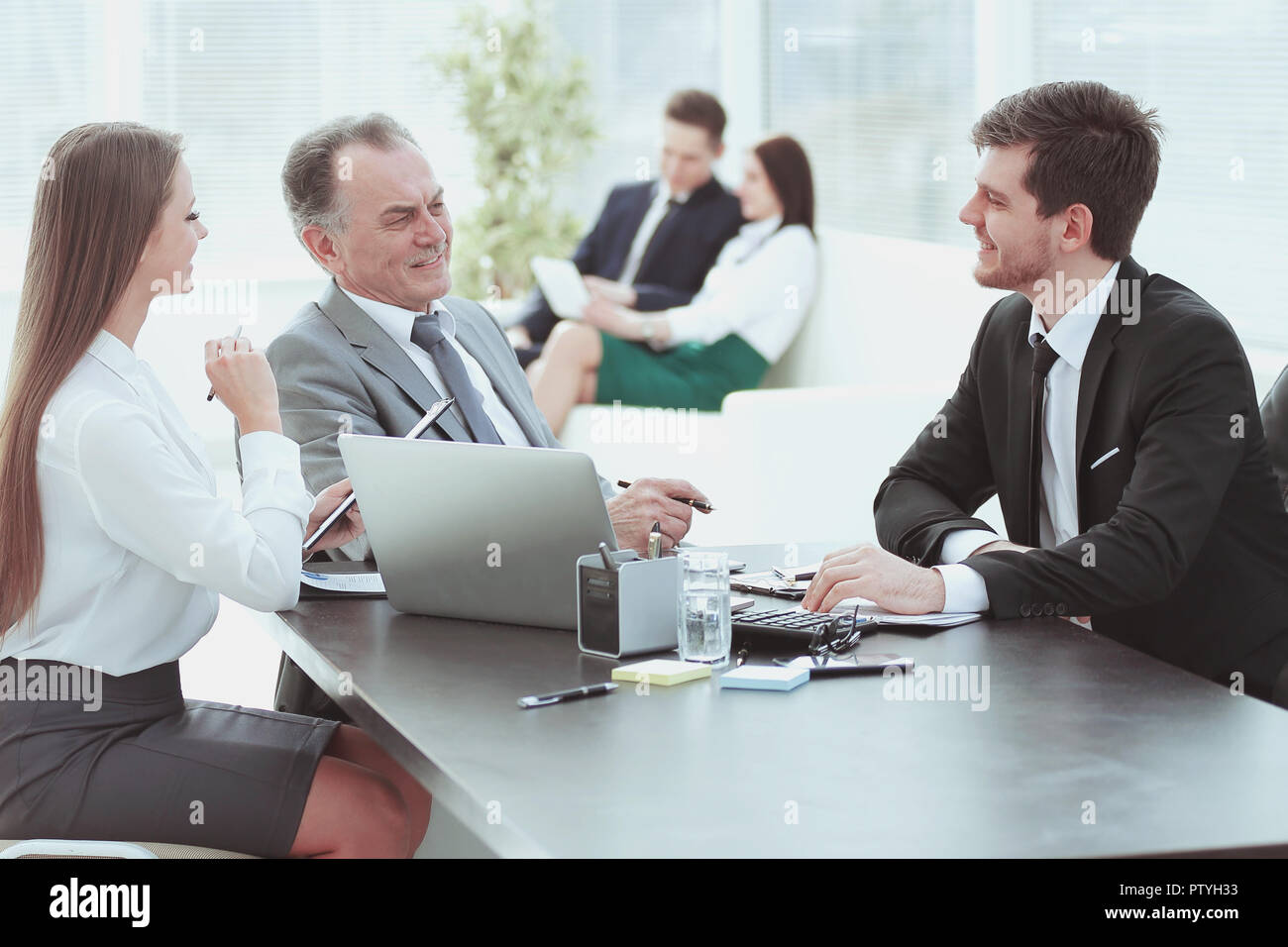 Colleagues talking reception desk hi-res stock photography and images ...