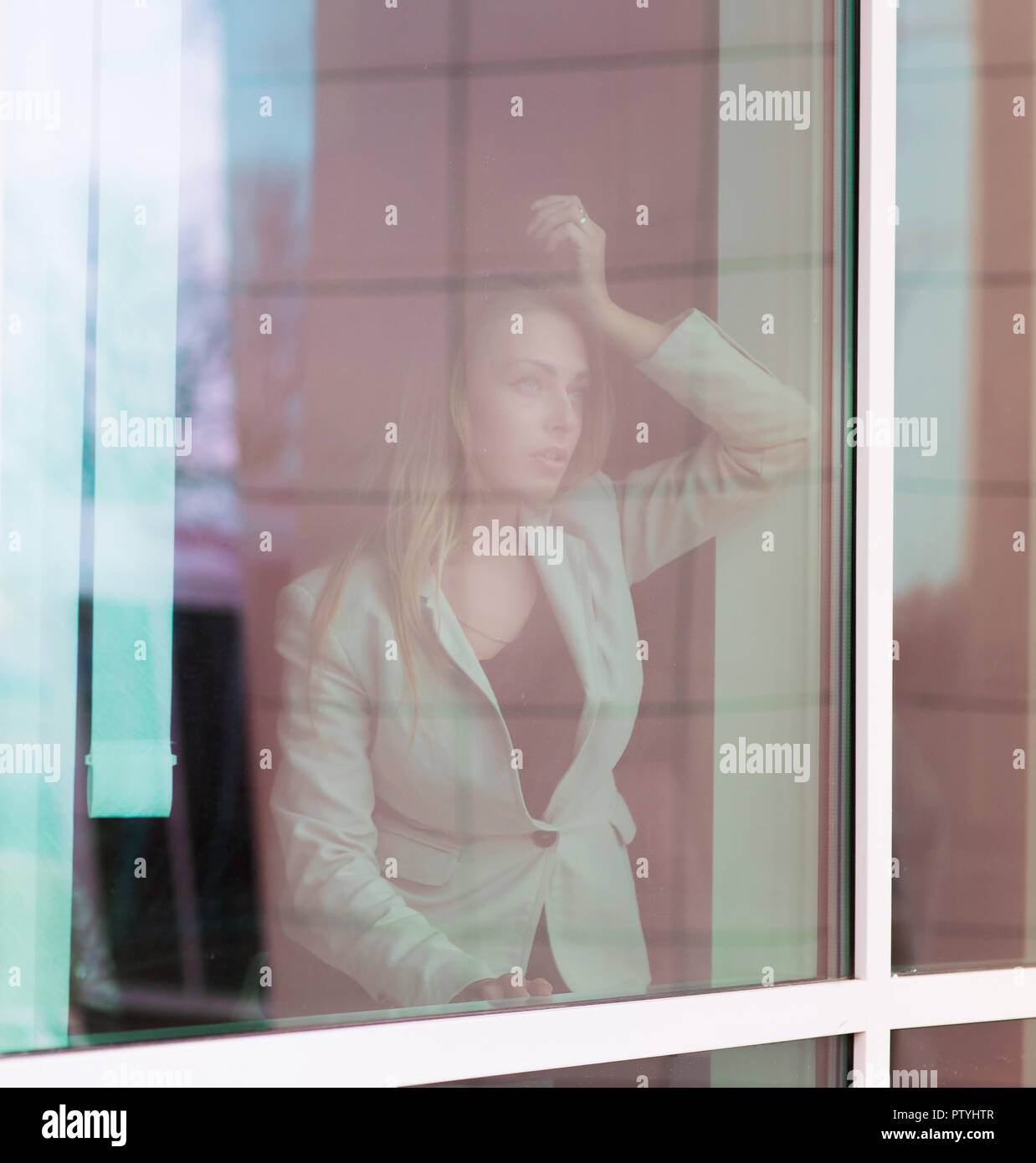 successful woman leader looks out the window of his personal office ...