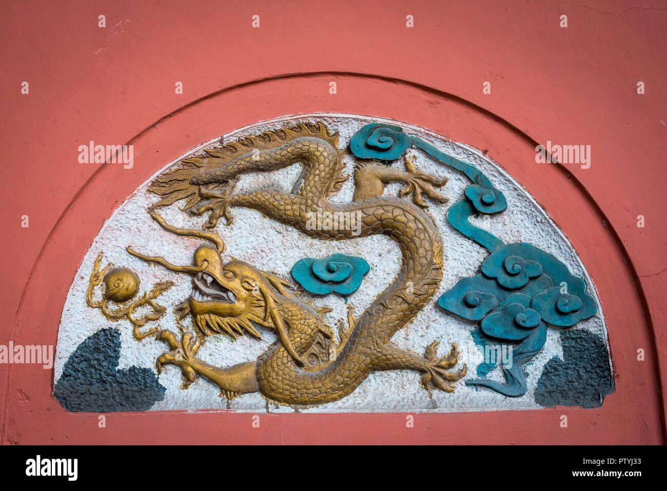 Dragon fresco bas-relief on a red wall in Wenshu monastery, Chengdu ...