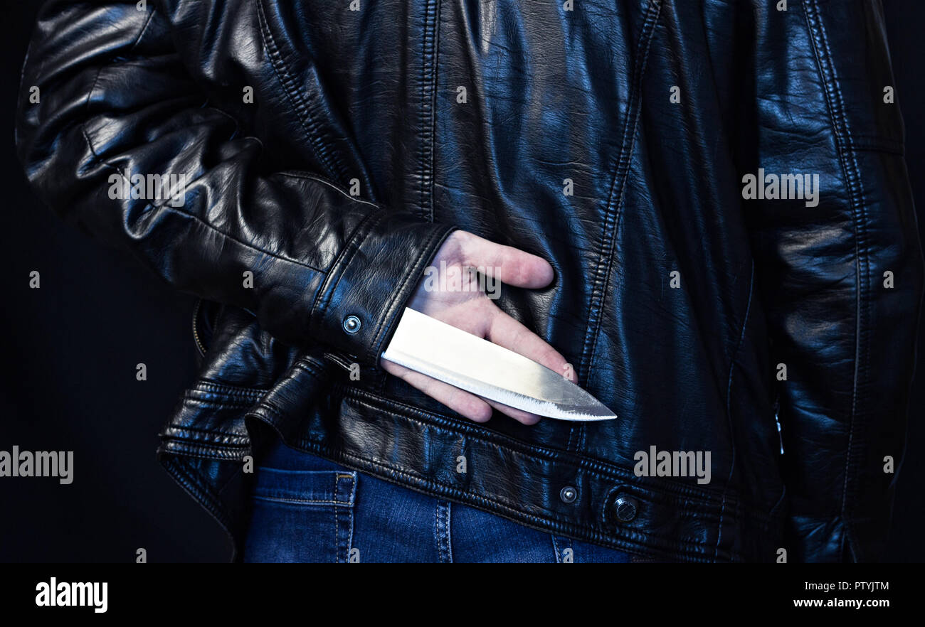 Man knife behind back hi-res stock photography and images - Alamy