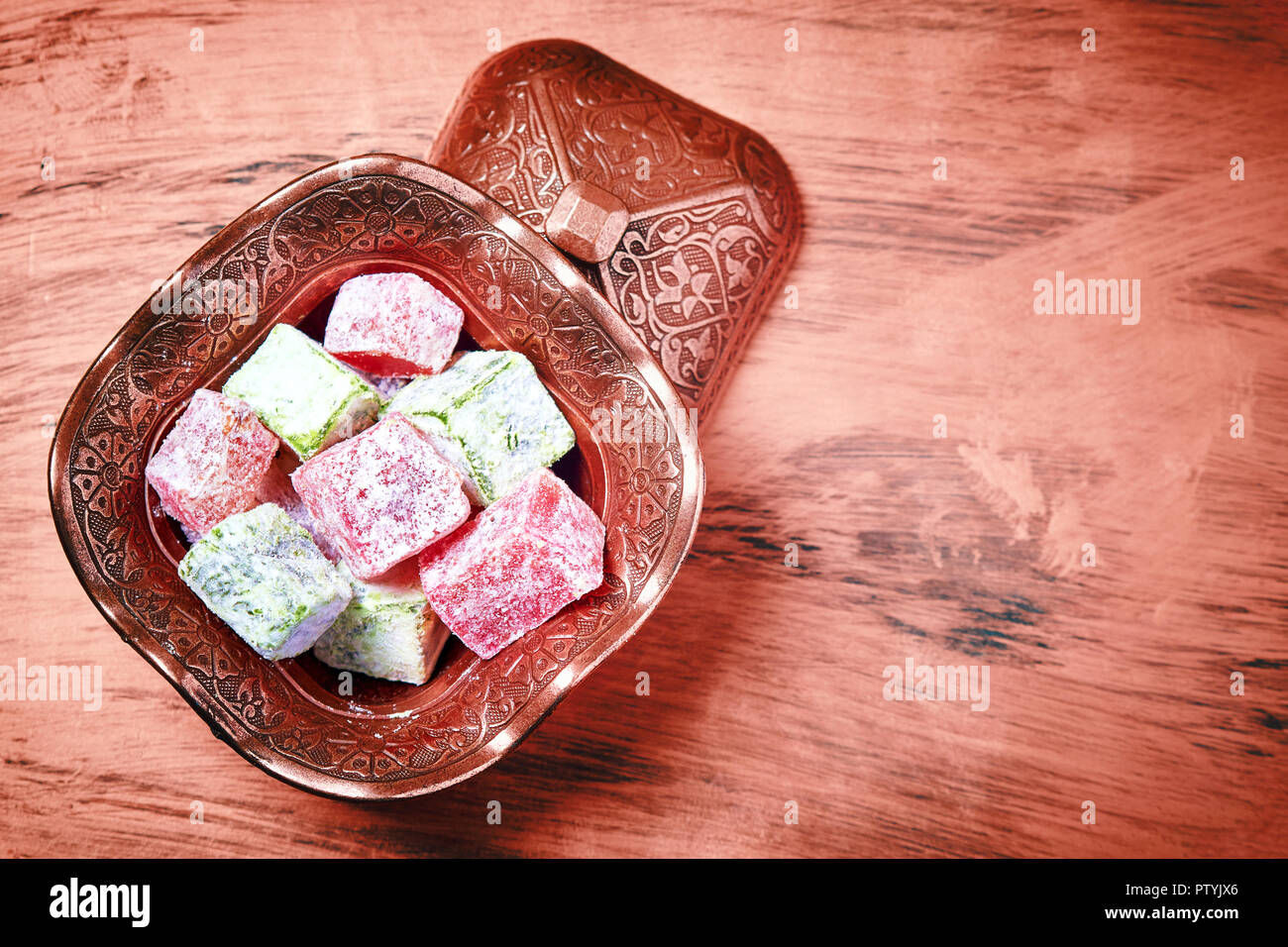 Turkish delight (lokum) in traditional oriental carved patterned metal ...