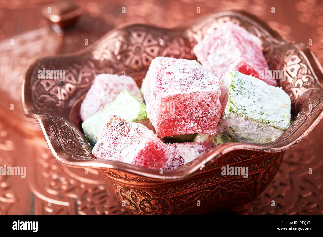 Turkish delight (lokum) in traditional oriental carved patterned metal ...
