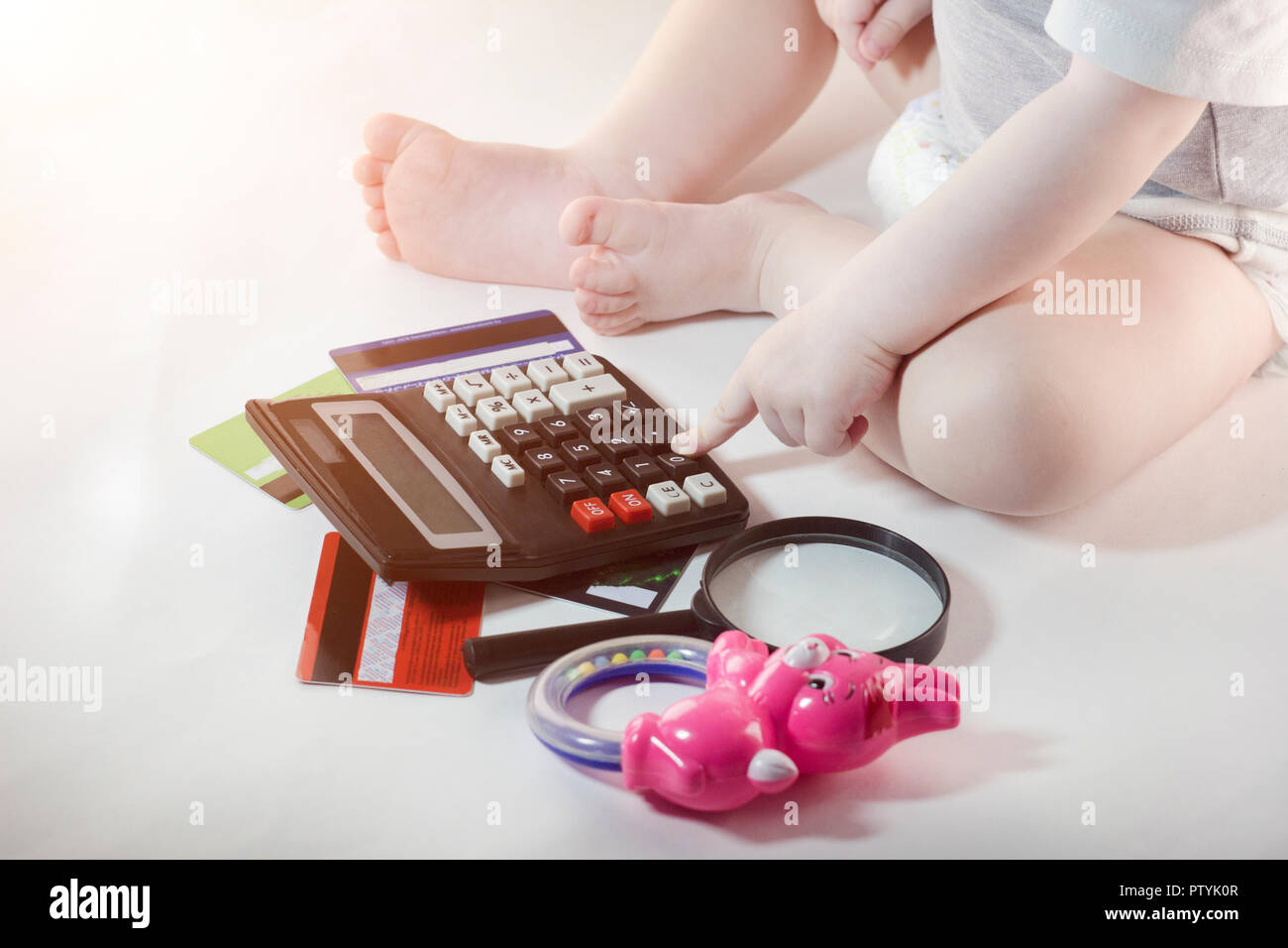 The child clicks on the calculator key, credit cards, white background ...