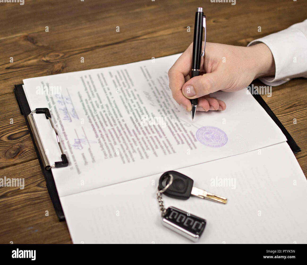 Buying a car, hand, keys, contract, seal, pen Stock Photo - Alamy