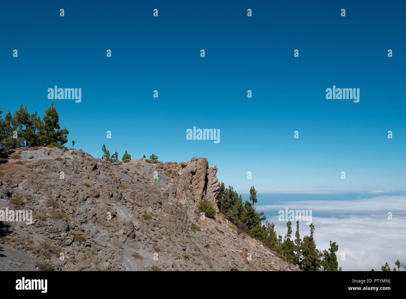 mountain cliff above clouds with clear blue sky background Stock Photo ...