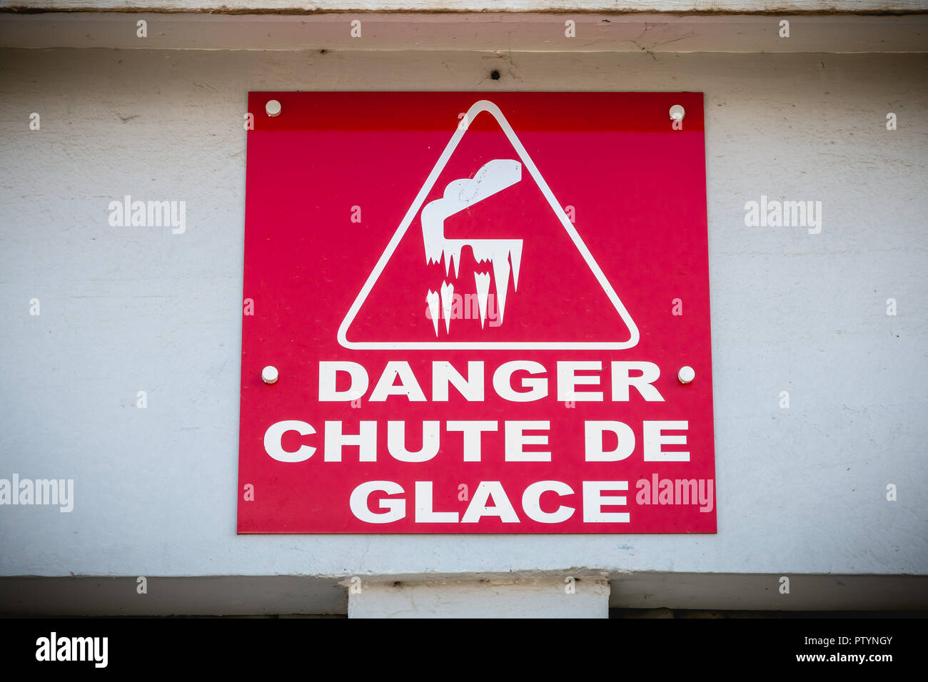 red sign in the mountains where it is written in French - danger ice ...