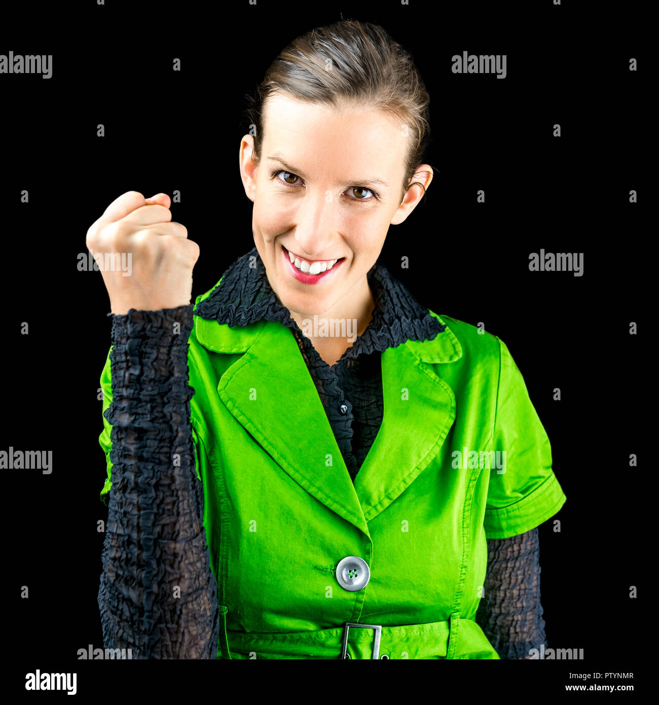 Happy successful business woman holding fist of success. Over black ...