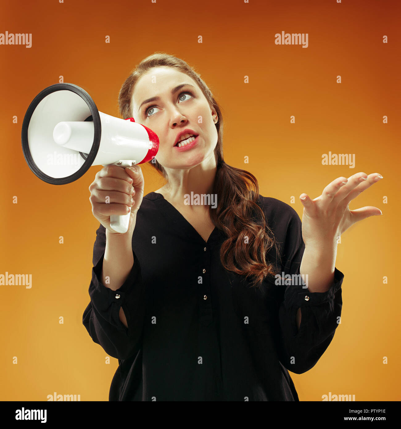 Woman making announcement with megaphone at studio Stock Photo - Alamy
