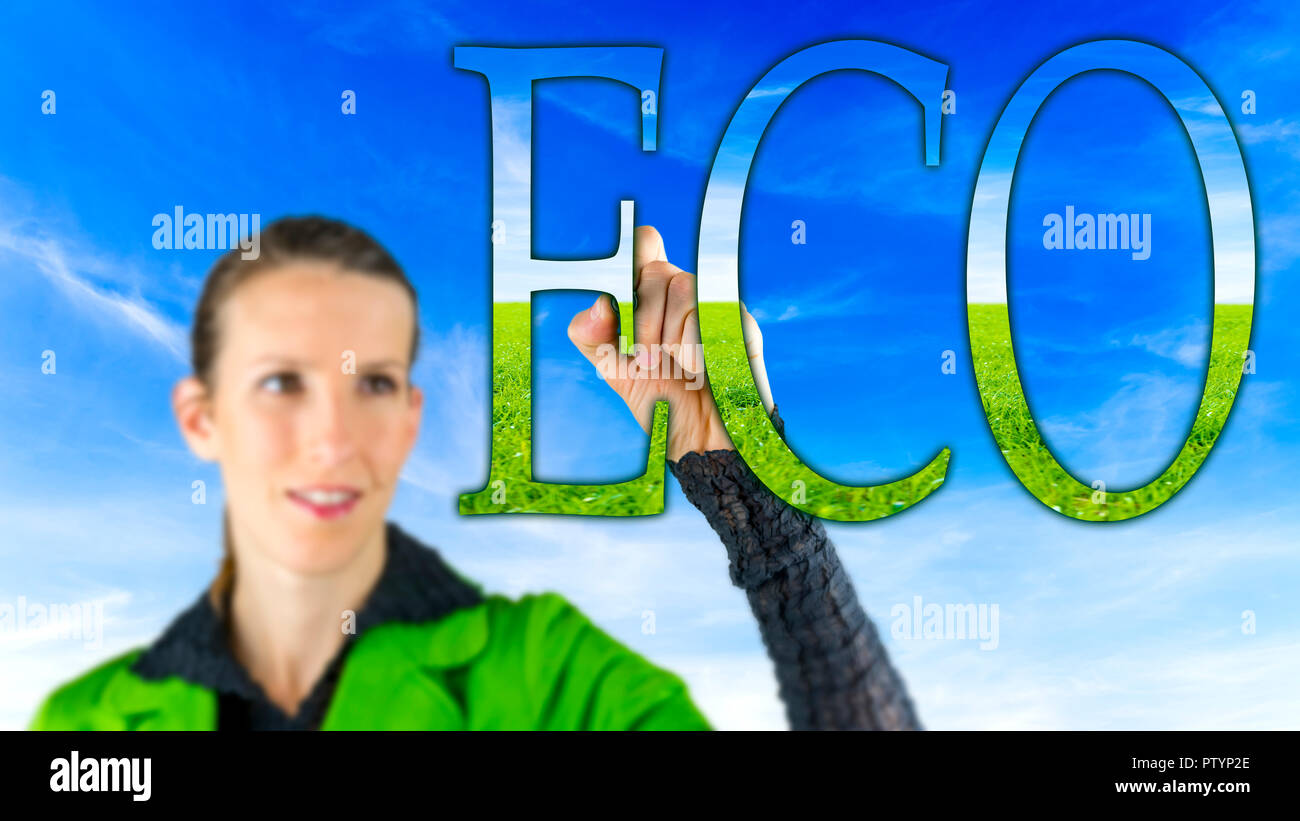 Young woman writing Eco sign on virtual screen Stock Photo - Alamy