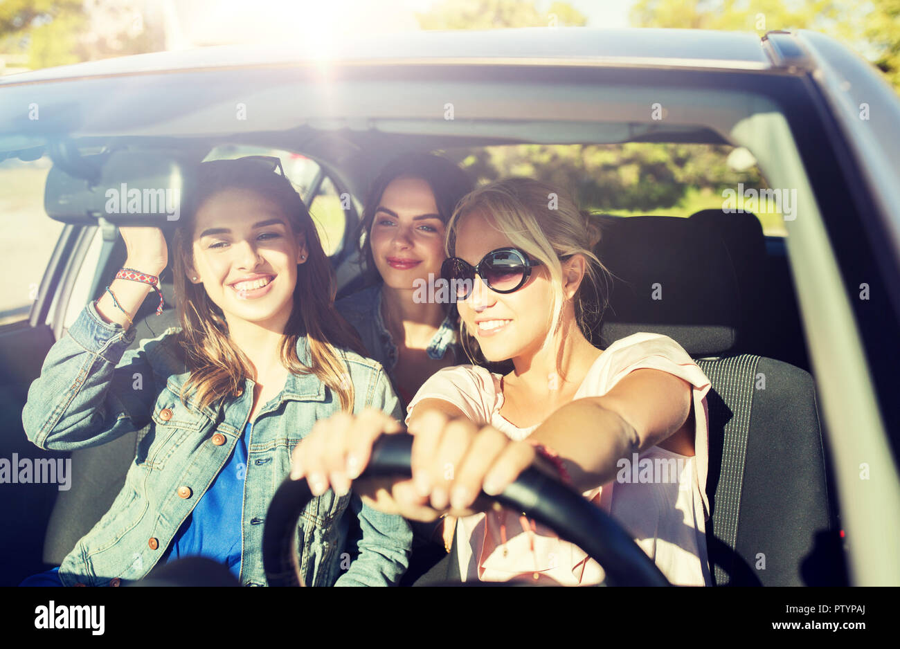 happy teenage girls or young women driving in car Stock Photo - Alamy