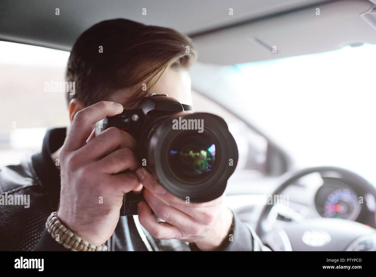 A photographer with a camera in the car is preparing to make an ...
