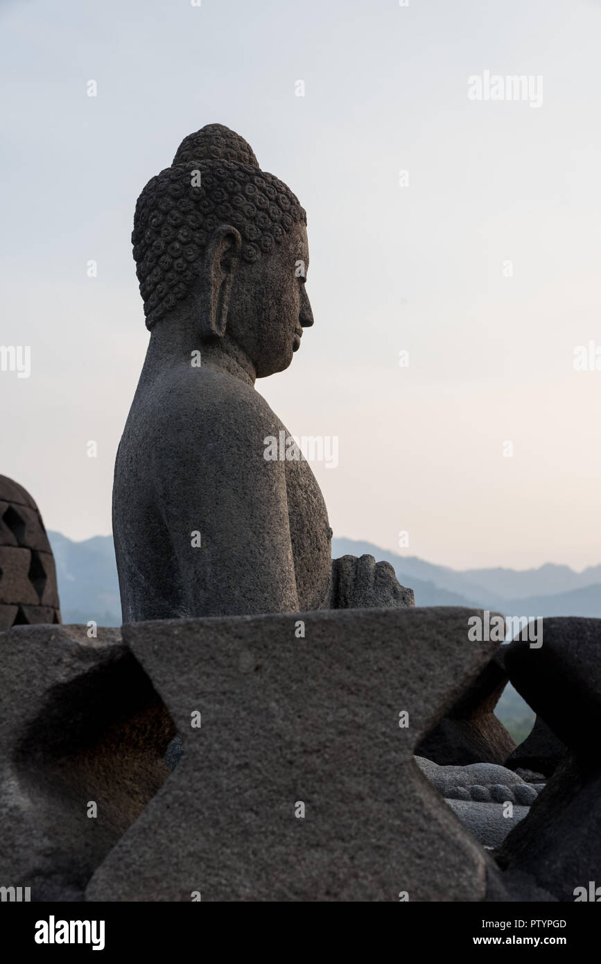 A Buddha statue in a buddhist complex in Java at sunset, Indonesia ...