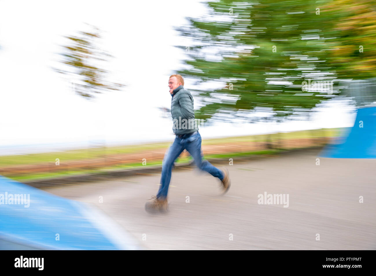 Blurred image of a man running Stock Photo - Alamy