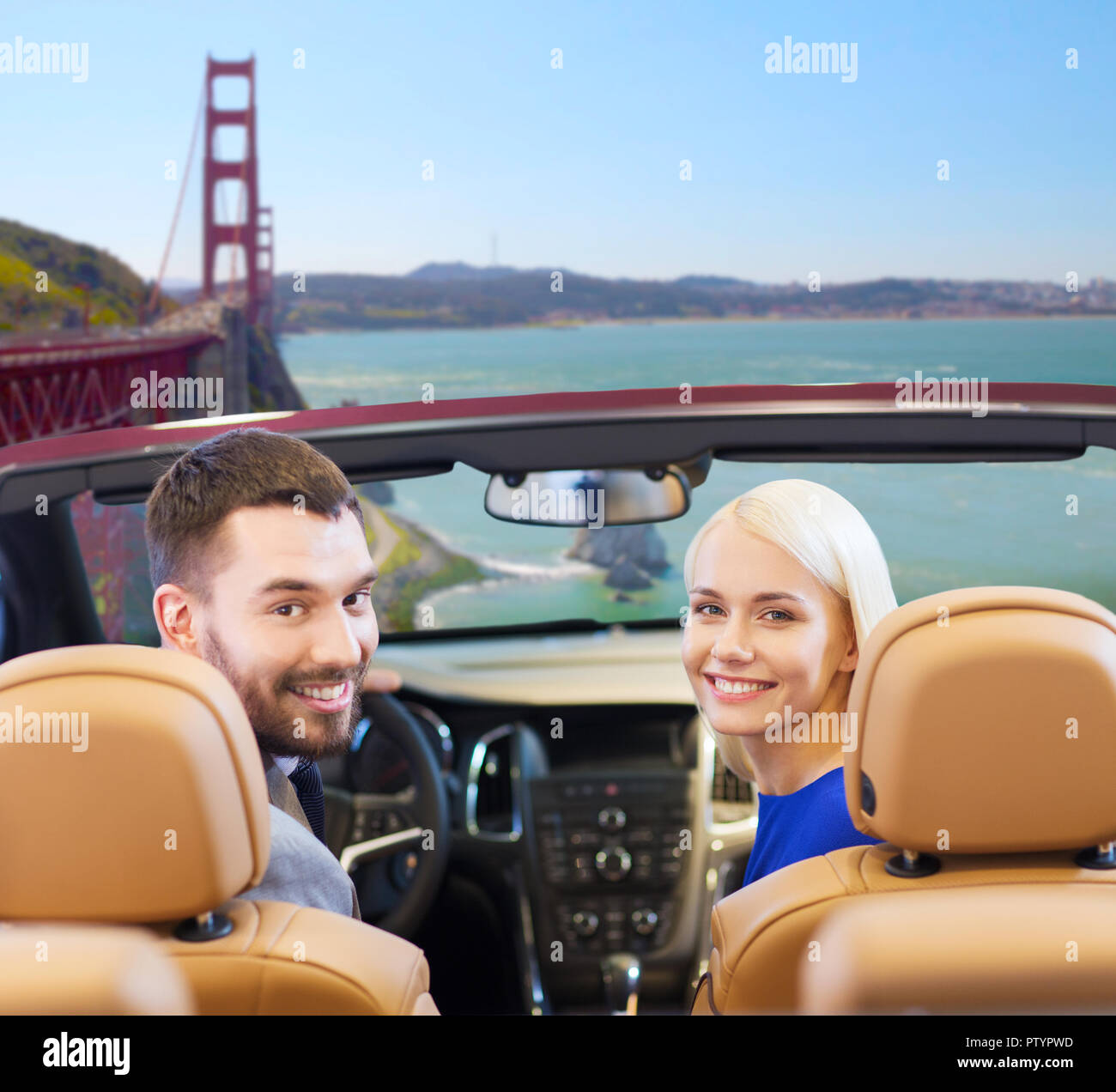 couple driving in convertible car and looking back Stock Photo - Alamy