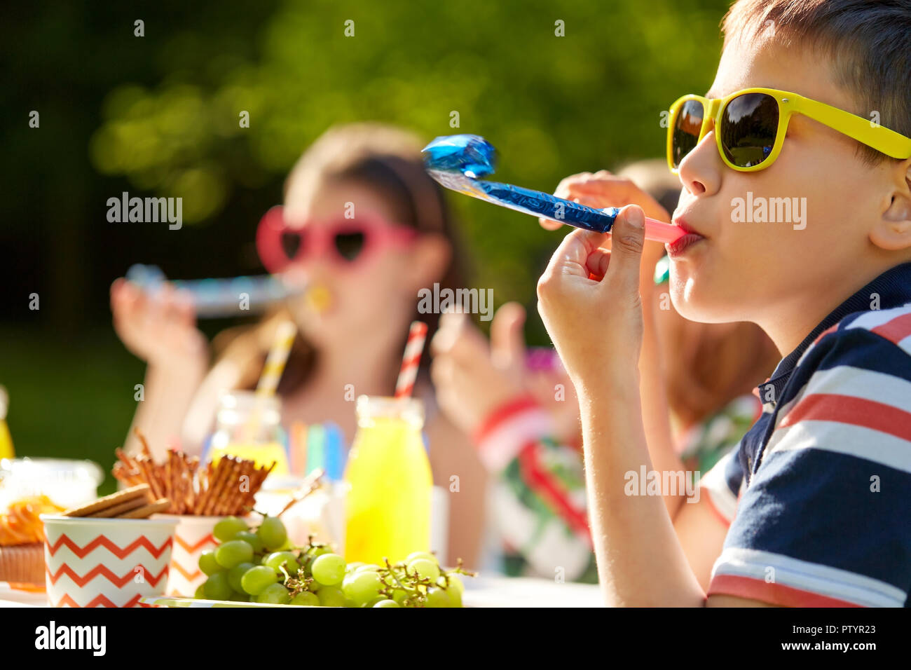 Boy blowing party horn hi-res stock photography and images - Alamy