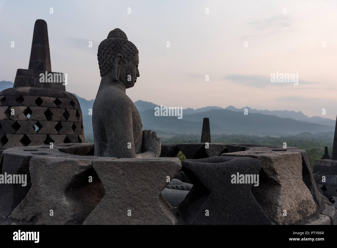 A Buddha statue in a buddhist complex in Java at sunset, Indonesia ...