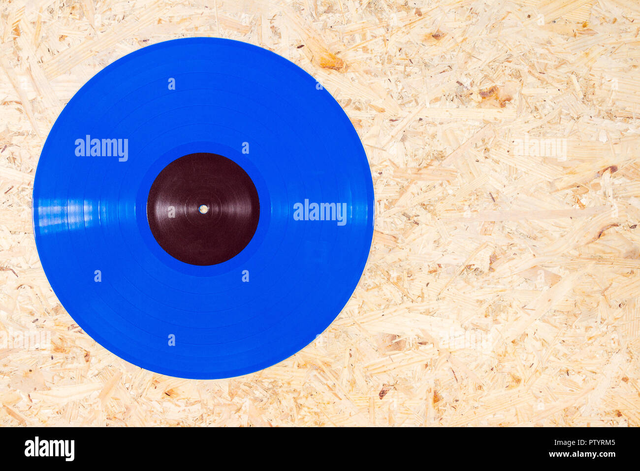 Blue color vinyl record with brown label on plywood background Stock ...