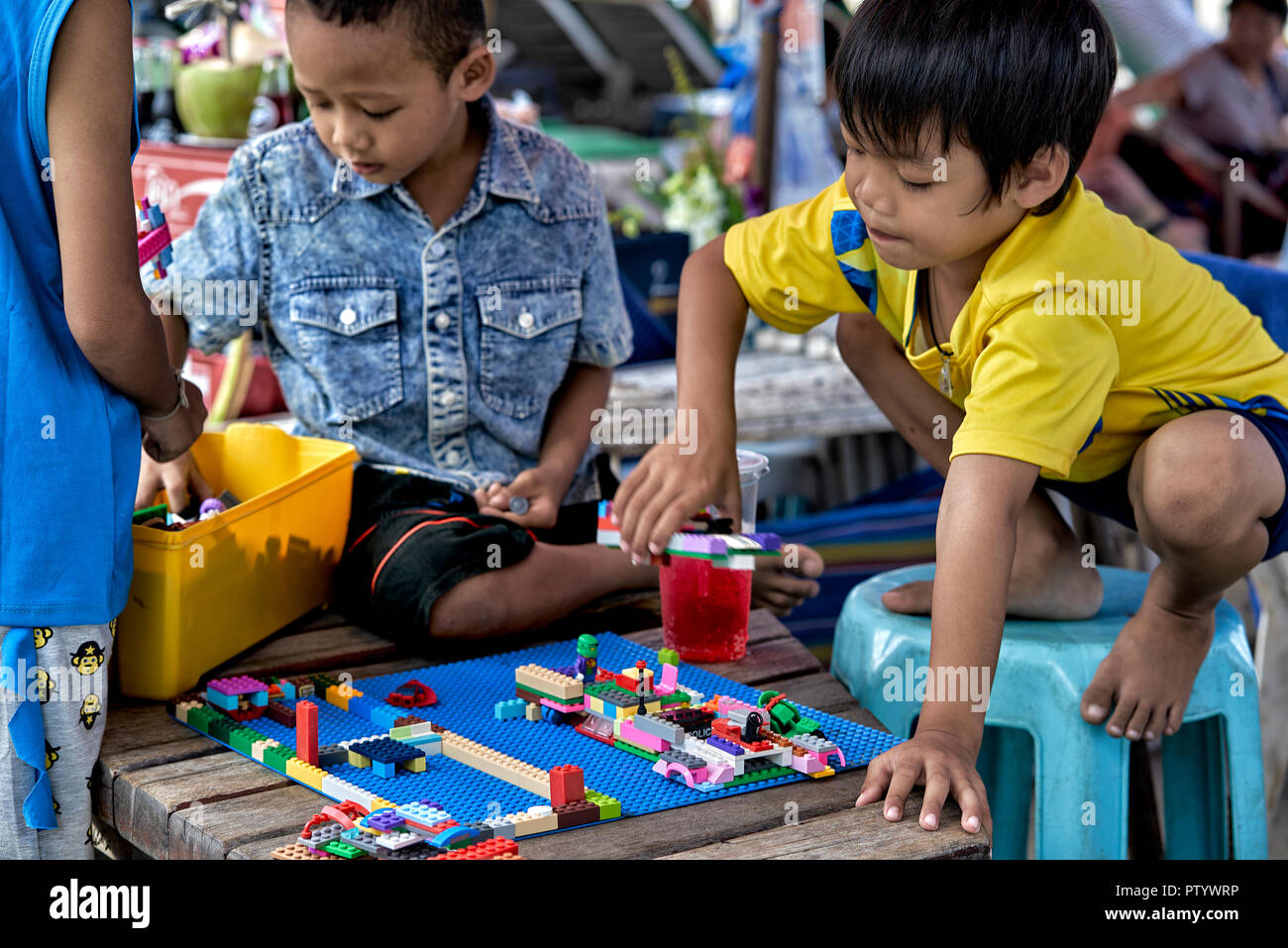 Lego. Children playing outside with a Lego building set. Thailand ...