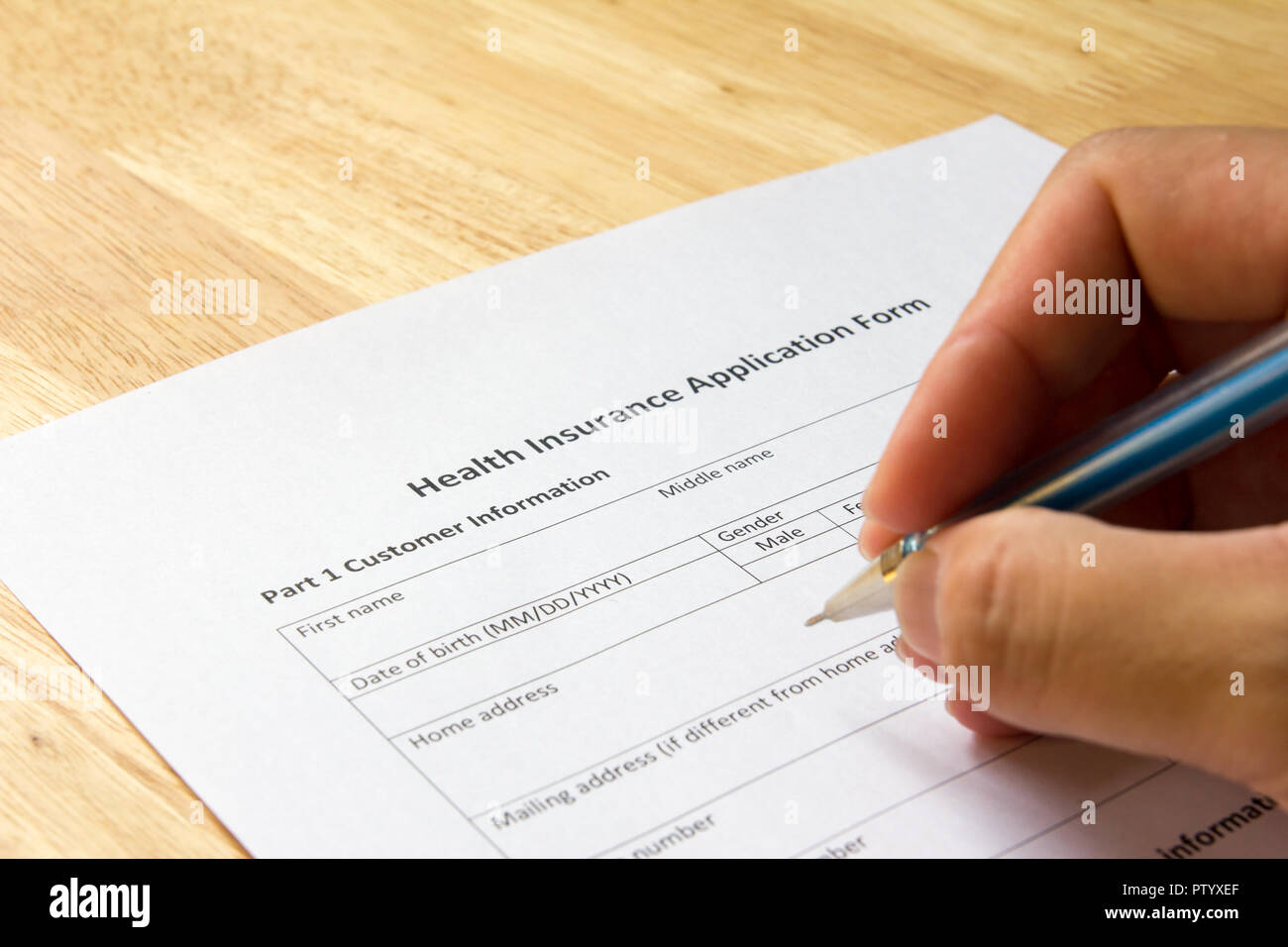 Man fill the health insurance application form Stock Photo - Alamy