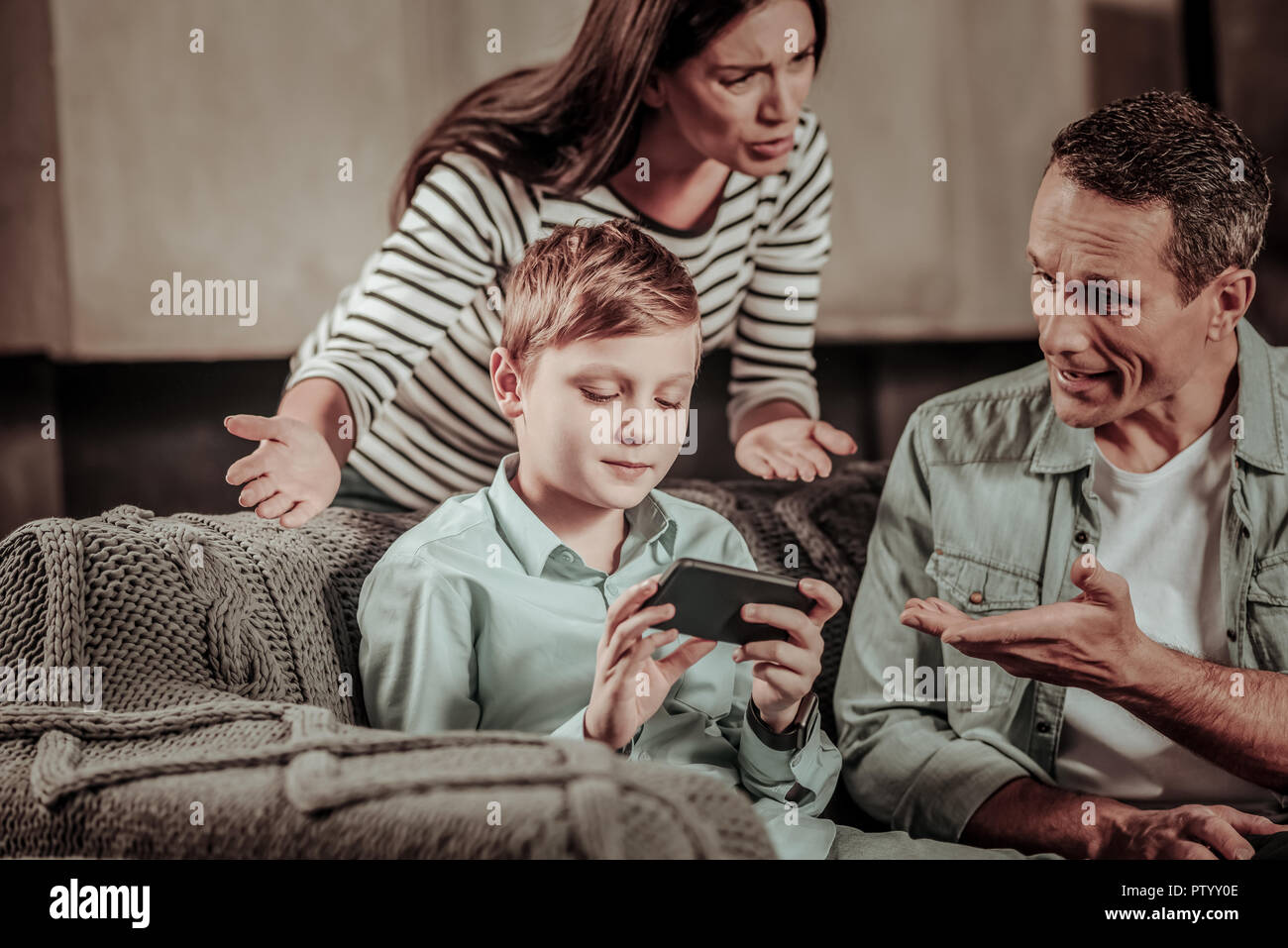 Pleased blonde boy being infatuated with his game Stock Photo - Alamy