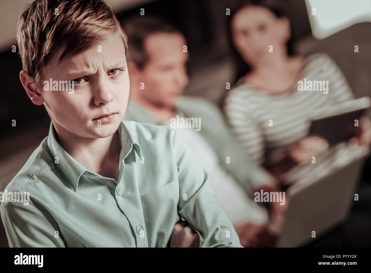 Angry kid wrinkling forehead while watching you Stock Photo - Alamy