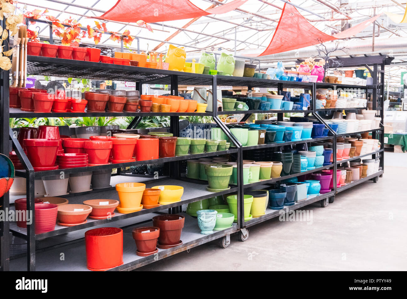 Variety of planting pots in different colors in garden center Stock ...
