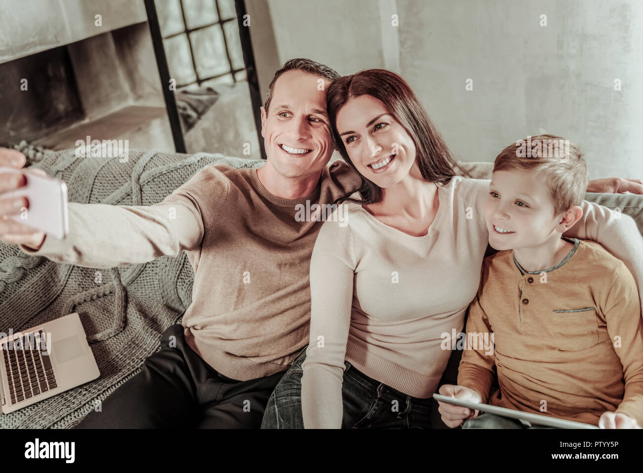 Happy young people looking at their camera Stock Photo - Alamy