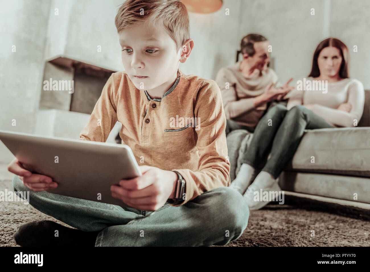 Attentive kid staring at screen of his gadget Stock Photo - Alamy