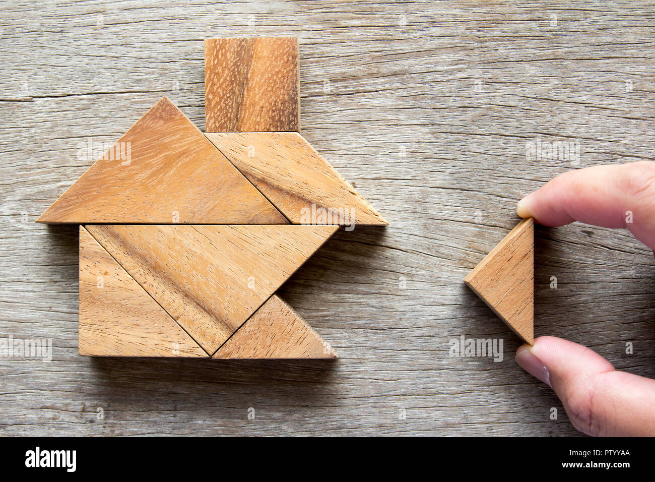 Wooden tangram puzzle wait to fulfill home shape for build dream home ...