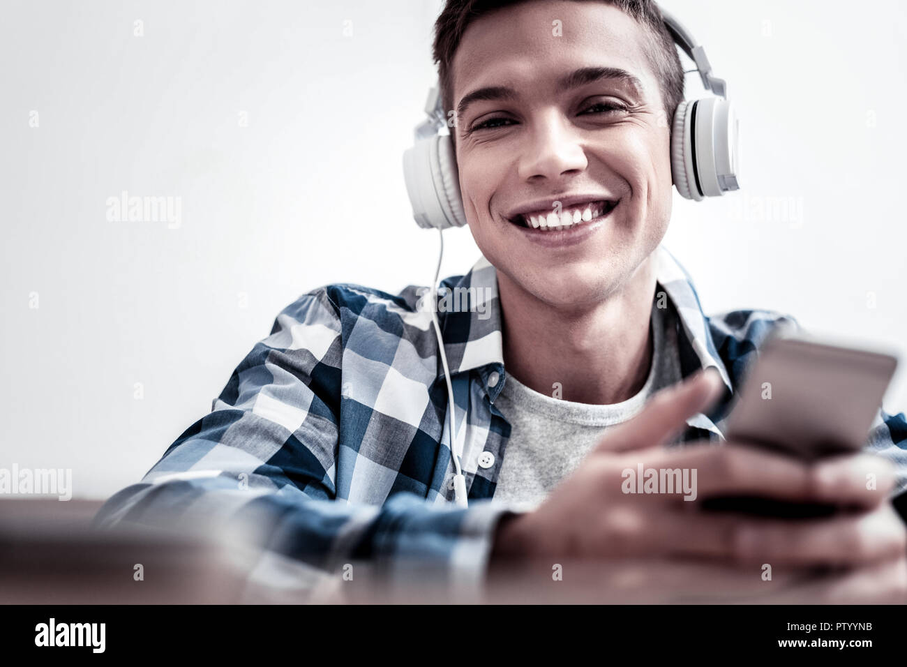 Positive student enjoying the music while wearing new headphones Stock ...