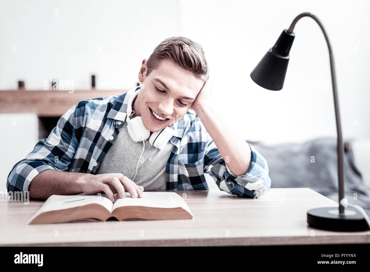 Emotional student feeling impressed and smiling while reading Stock ...