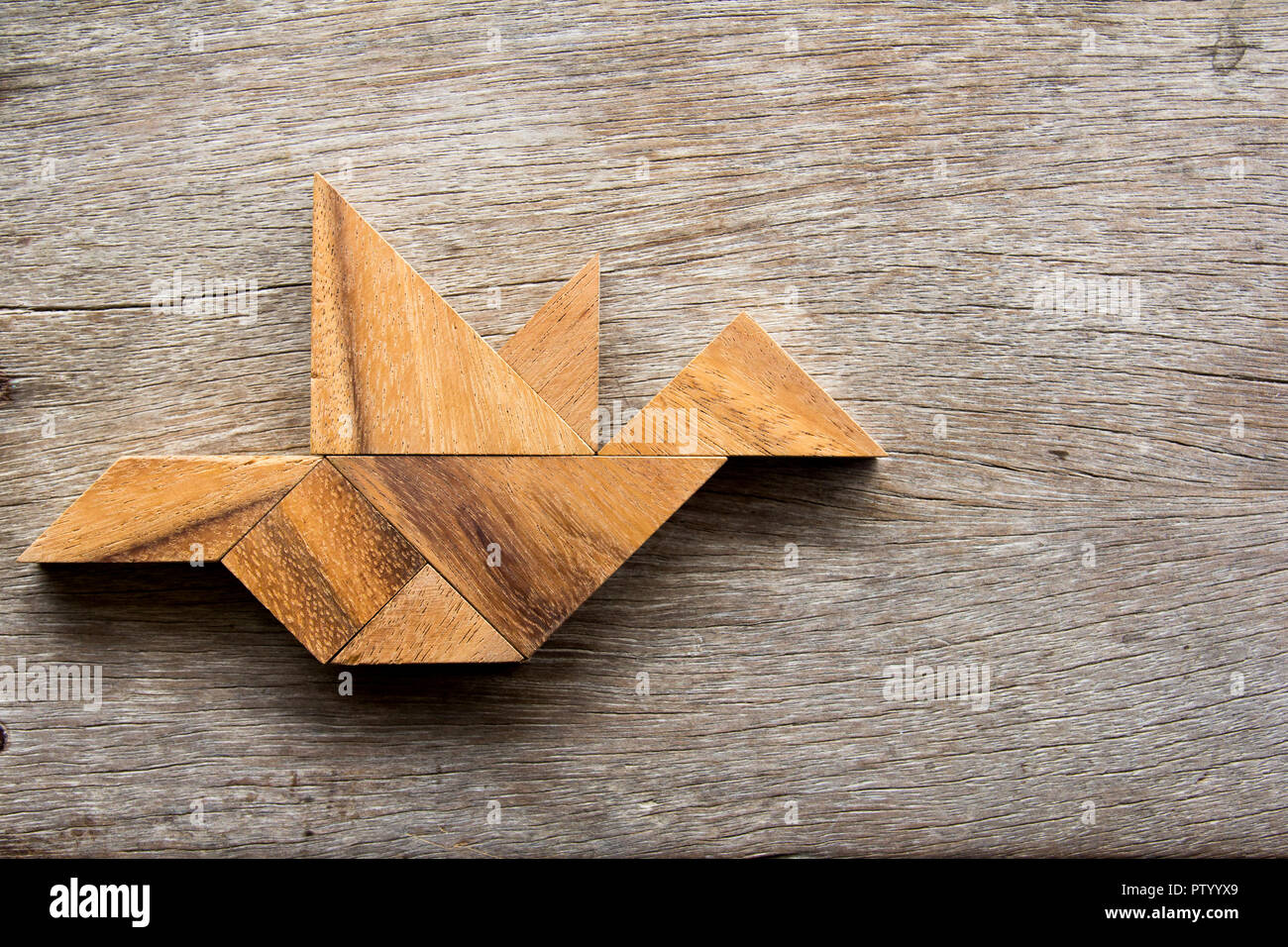 Wooden tangram puzzle in bird shape background Stock Photo - Alamy