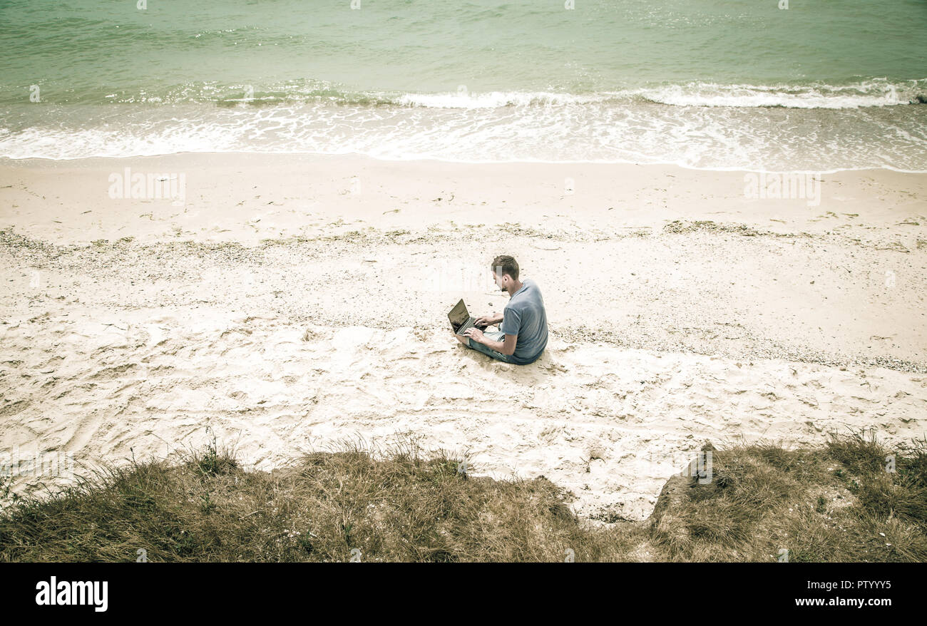 man running on the computer, in nature, to work on the beach Stock ...