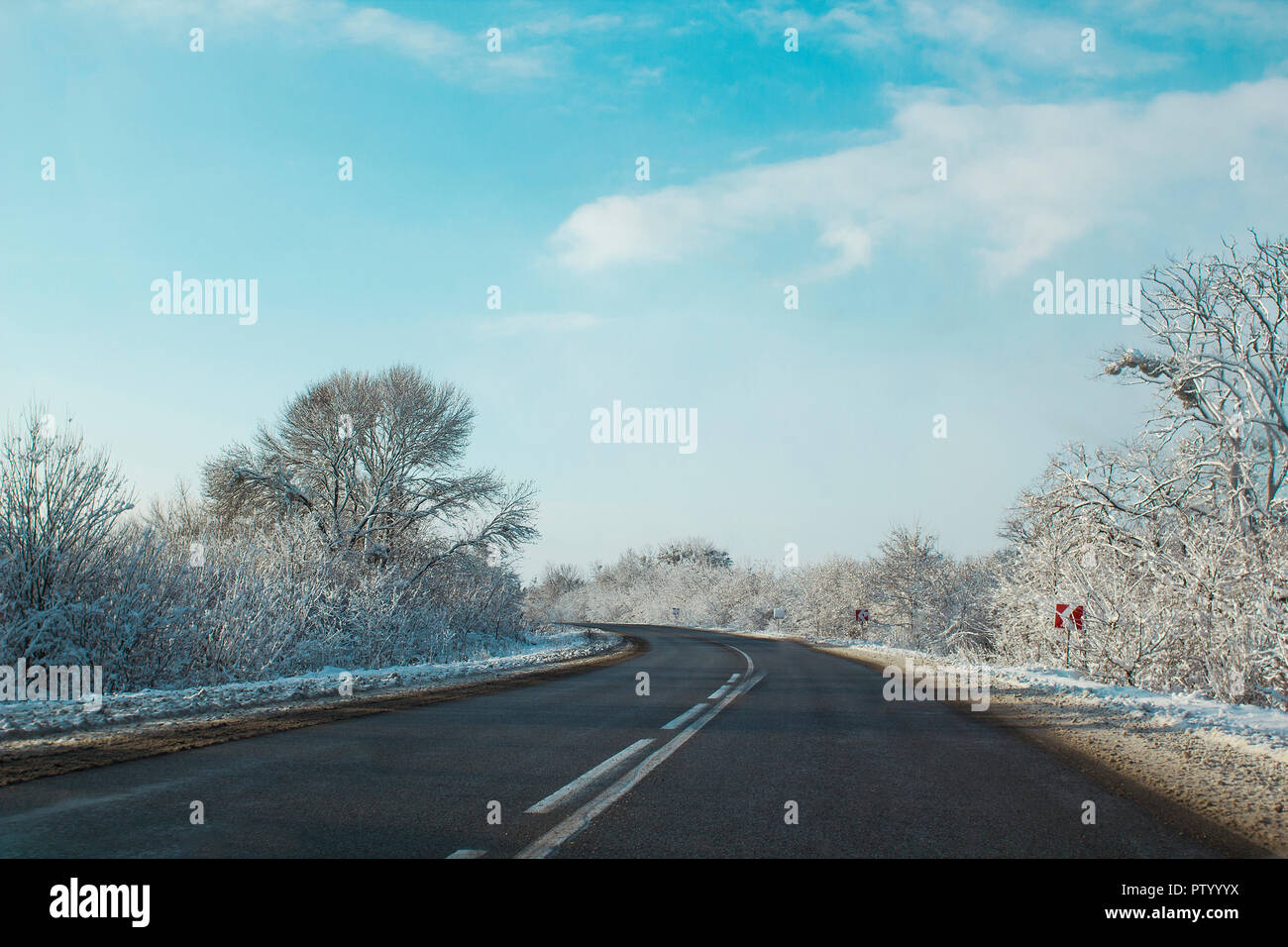 Winter road ahead. Christmas frozen landscape with empty highway, icy ...