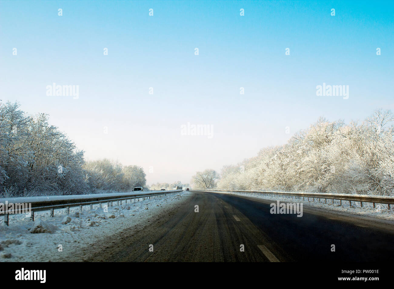 Winter road ahead. Christmas landscape with highway and driving cars ...