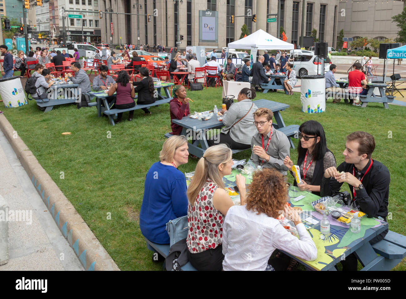 Detroit, Michigan - People eat lunch on a warm autumn day in Spirit ...