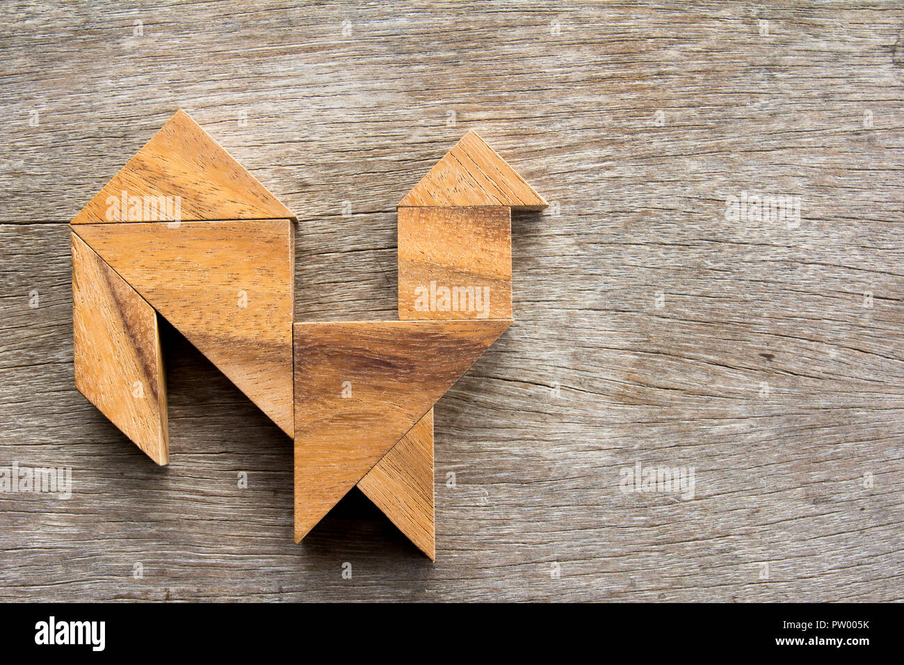 Wooden tangram puzzle in rooster shape background Stock Photo - Alamy