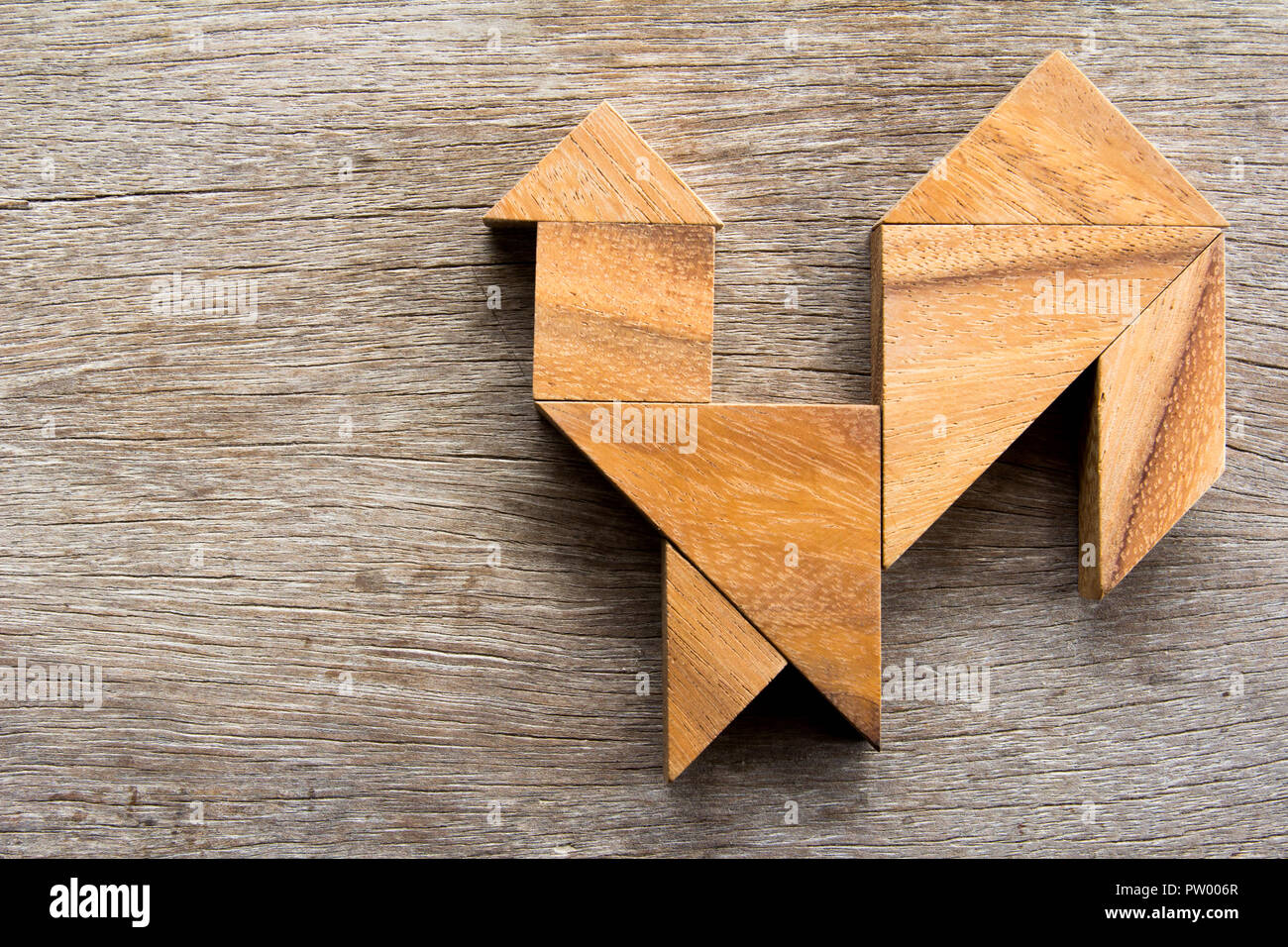 Wooden tangram puzzle in rooster shape background Stock Photo - Alamy