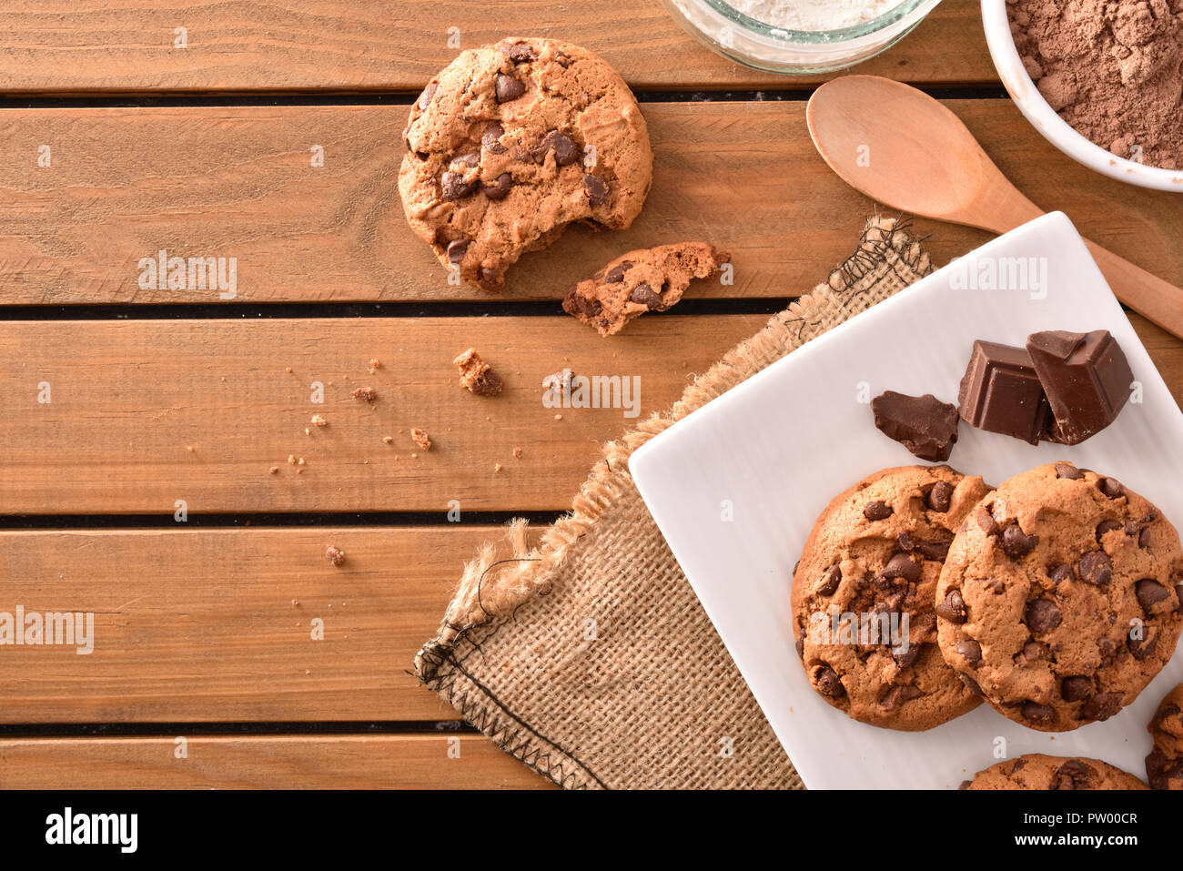 Homemade biscuits with chocolate chips on wooden slatted table with ...