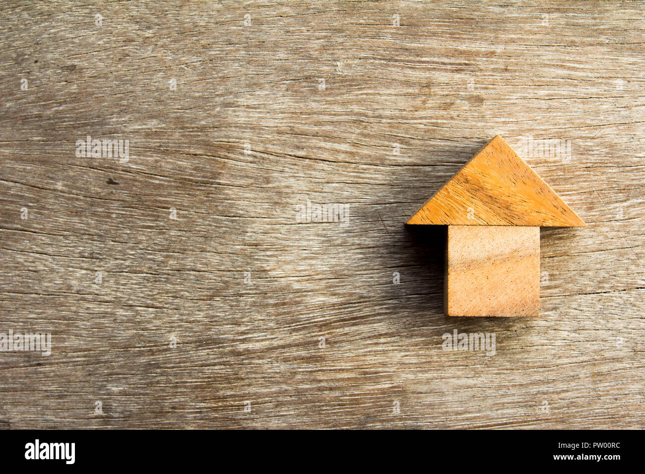 Wooden tangram puzzle in home shape for dream home or happy life ...