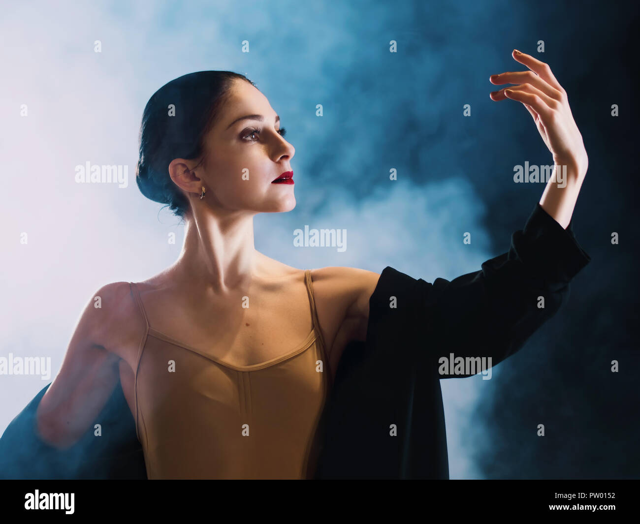 Young beautiful ballerina on smoke stage dancing modern ballet ...